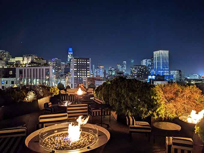 Fire bowls dot the terrace like campfires in an urban forest as the city lights up.