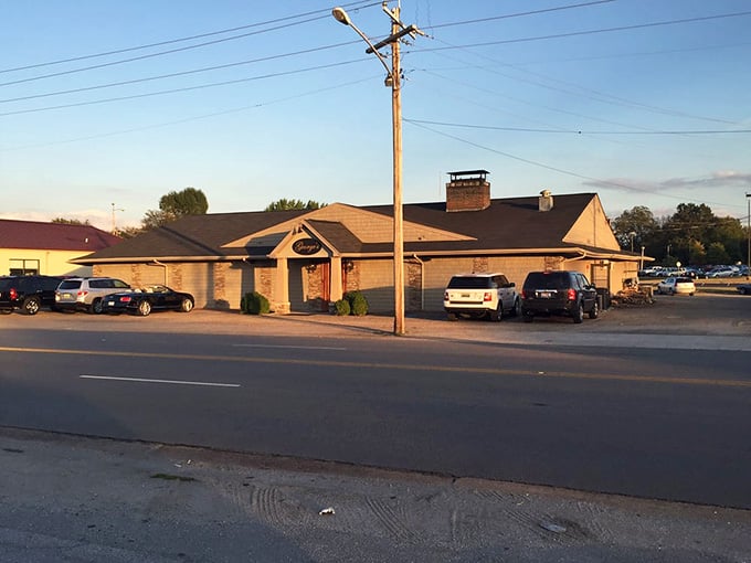 Golden hour bathes this classic roadside spot where locals have gathered for decades over perfectly cooked cuts.