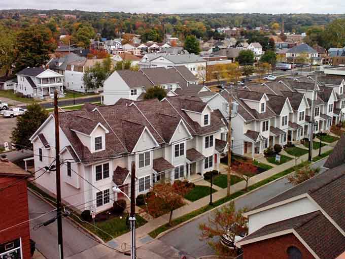 Neat rows of townhomes stretch toward the horizon, offering affordable retirement living with neighbors close enough to borrow sugar.