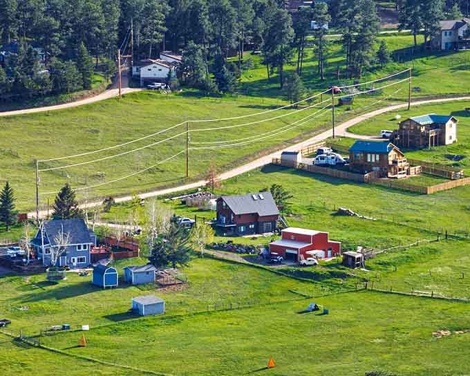 Power lines connect hillside houses where space between neighbors means privacy and spectacular sunset views.