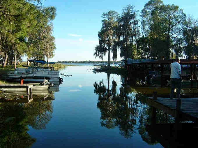 Morning mist hovers over the glassy lake surface, creating a scene so peaceful it could lower your blood pressure.