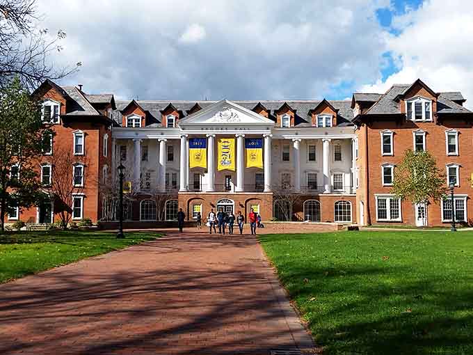 This grand college building welcomes visitors with white columns and colorful banners that add youthful energy to historic architecture.
