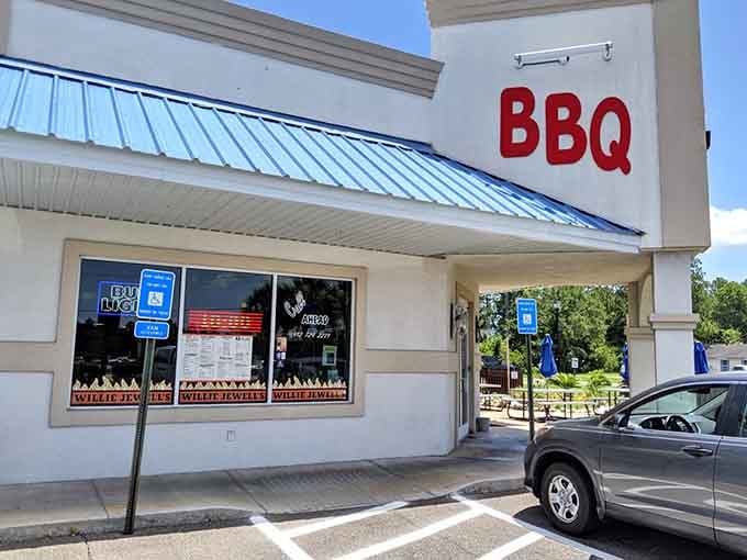 The welcoming entrance and blue metal roof signal a barbecue joint that respects tradition while serving generous portions.