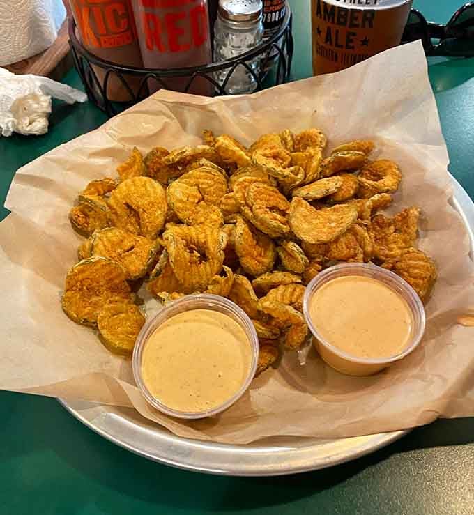 Golden fried pickles with creamy dipping sauce: the Southern appetizer that converts skeptics into believers instantly.