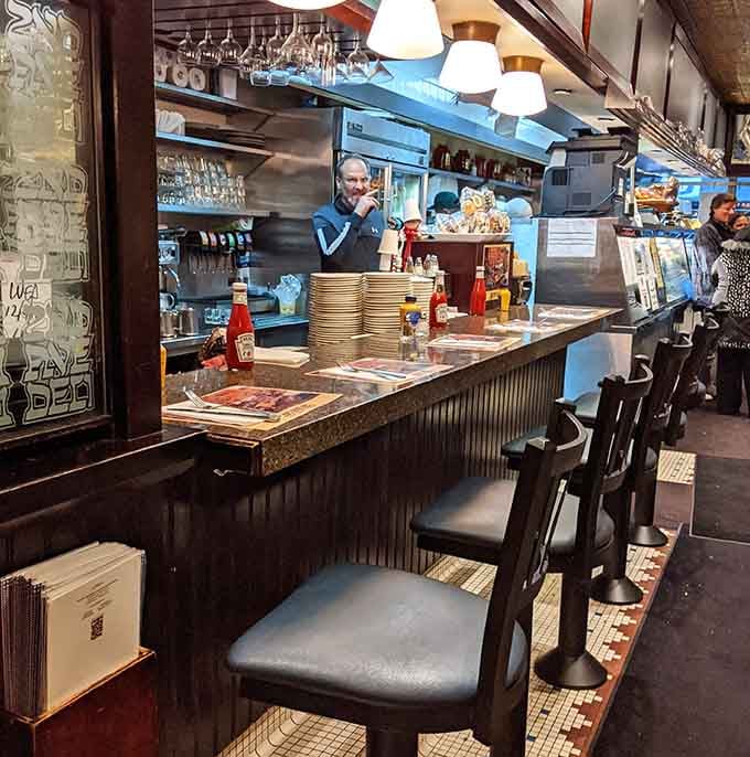 Counter seating offers front-row views of deli magic happening, where sandwiches are built like edible skyscrapers.