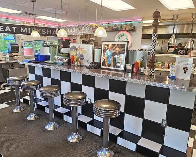Classic counter stools and checkered tile create the perfect spot for solo diners and conversation starters alike.