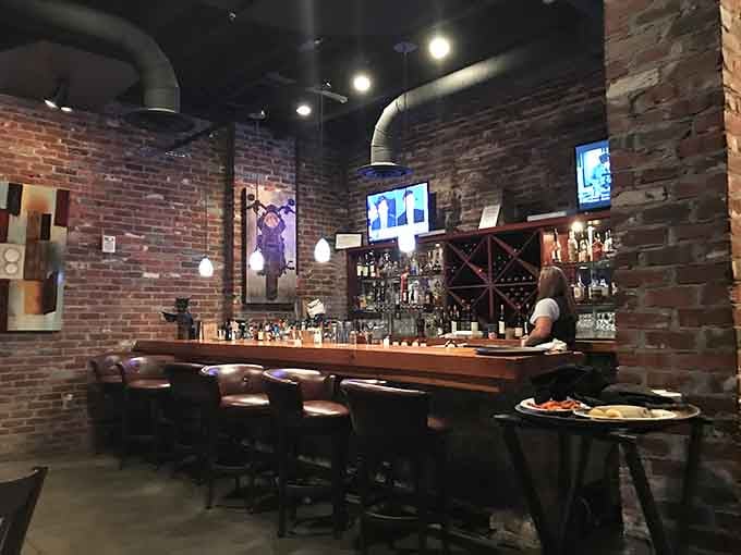 The bar area features exposed brick and enough bottles to keep things interesting beyond the dinner menu.