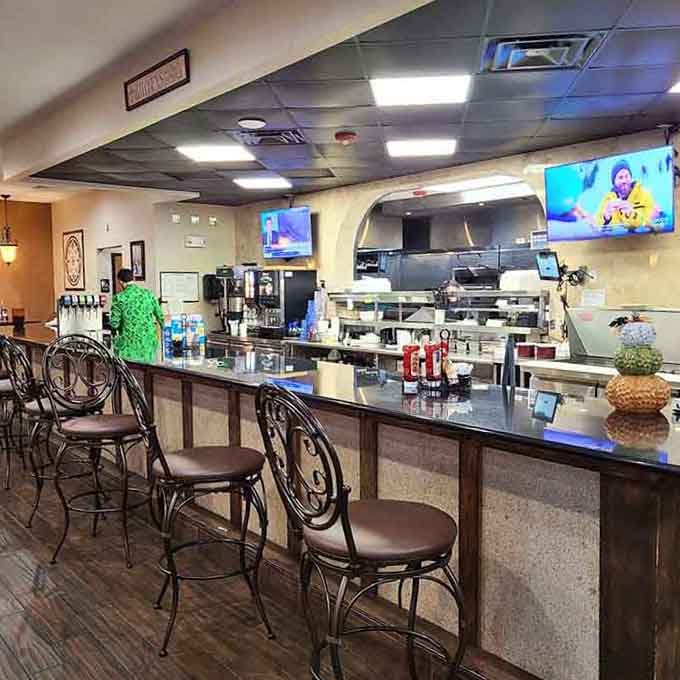 The bar area features comfortable seating and a view into the kitchen where all the magic and massive portions happen.