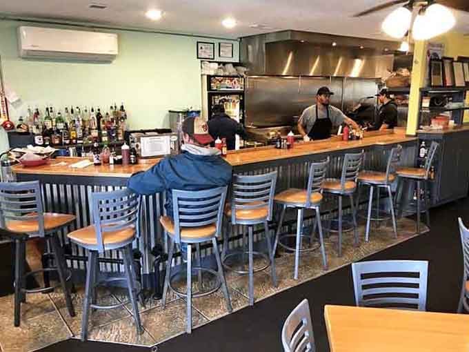 The open kitchen and bar setup lets you watch the magic happen while you wait for your own plate.