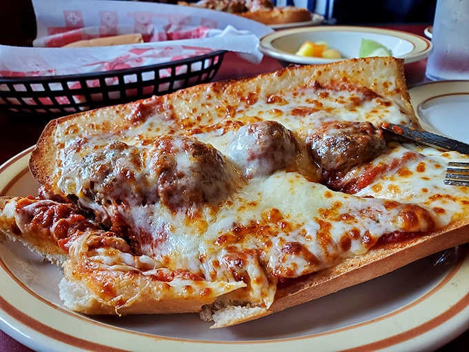The meatball sub arrives open-faced and loaded, requiring both hands and possibly a strategic eating plan to conquer.