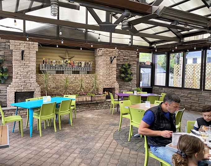 The back patio with bright chairs and string lights turns any meal into a mini vacation.