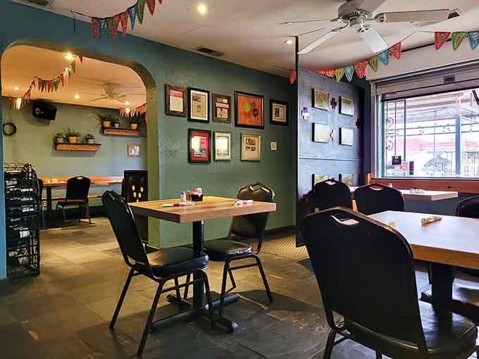 Framed artwork on turquoise walls adds character to a dining room where countless memories have been made over shared meals.