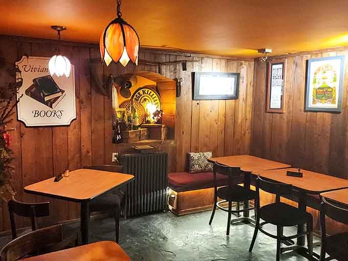 Wood-paneled walls and vintage signs create a cozy tavern vibe within these ancient stone walls.
