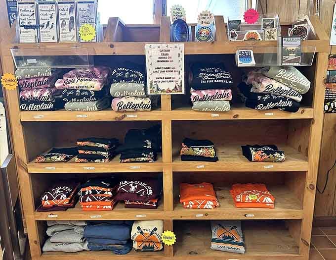 A treasure trove of folded memories: school spirit wear stacked like colorful chapters in a hometown story.