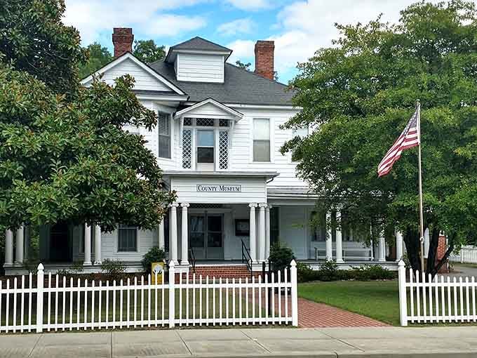 The County Museum's white picket fence and American flag combo is peak small-town Southern charm.