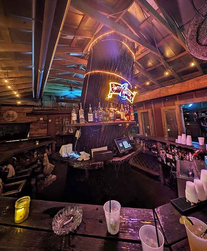 The bar area features that distinctive tree trunk design, perfect for enjoying a pre-dinner cocktail in style.