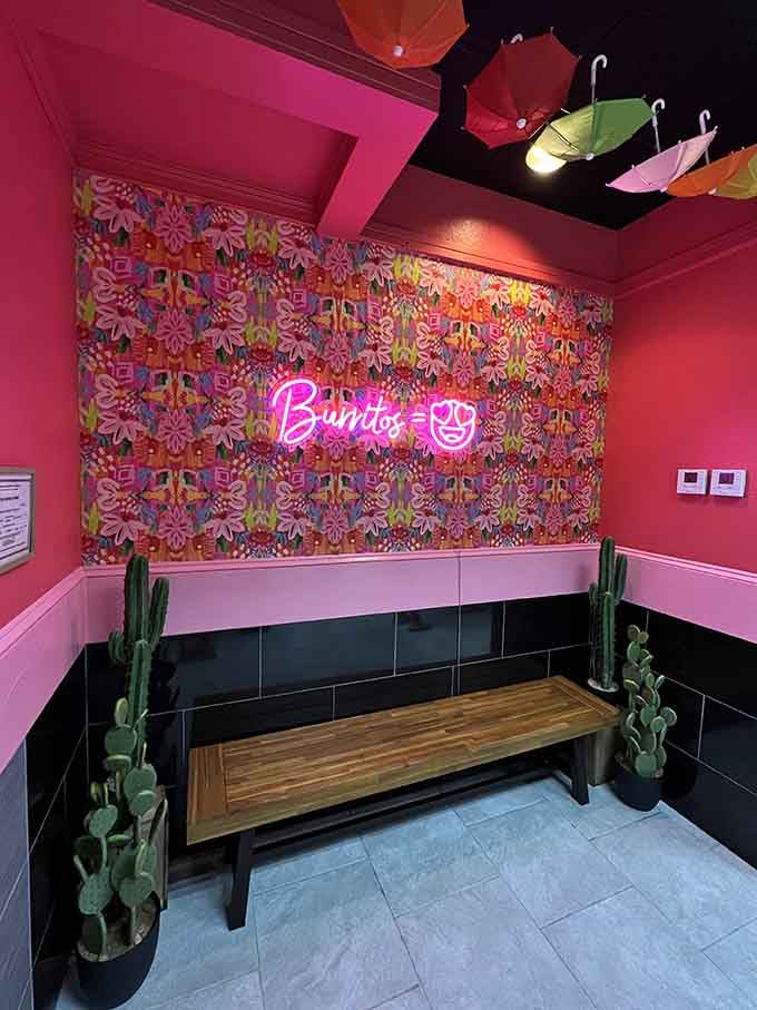 Instagram-worthy neon sign and floral wall proving that even no-frills spots can have a little personality and flair.