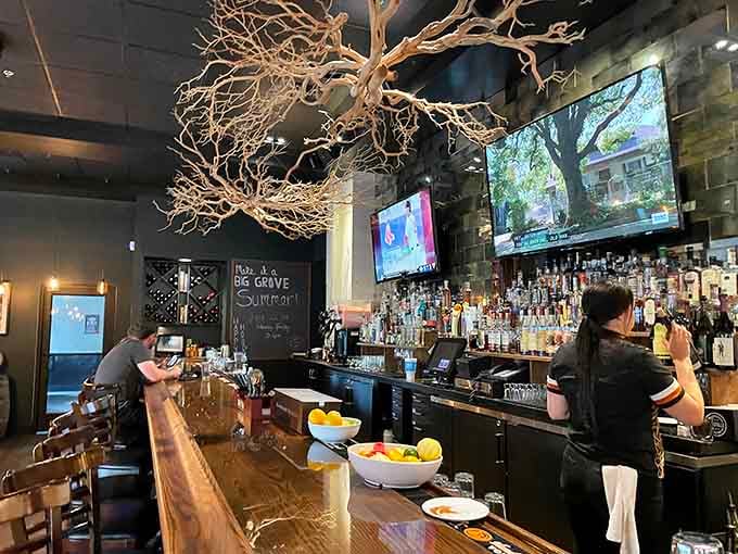 That well-stocked bar backed by screens and an artistic branch sculpture means serious business about craft cocktails.