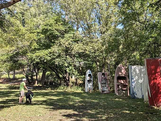 Cyclists cruise past on their way to discover why Missouri decided boats belong in the sky.