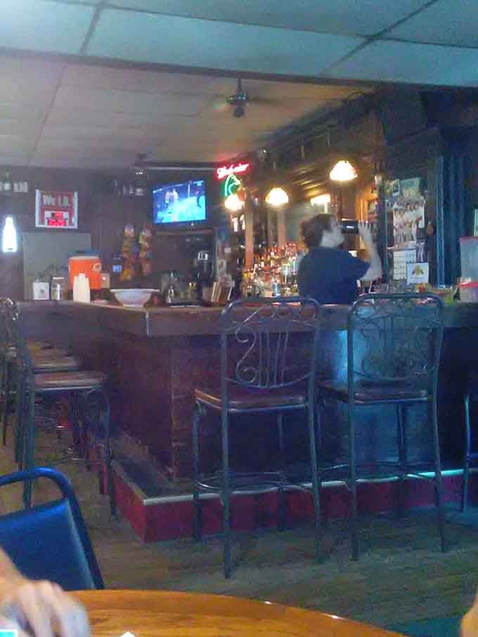 The bar where locals gather, stories flow, and cold drinks wait to accompany your upcoming feast perfectly.