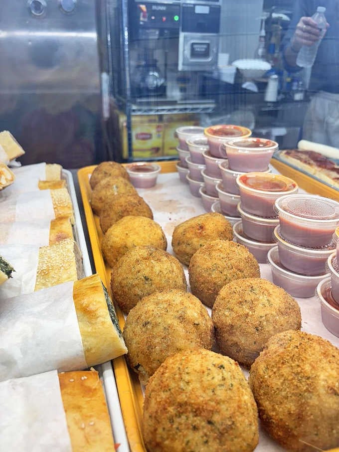 Golden arancini sitting there like edible treasures just waiting to be discovered by the next lucky customer.