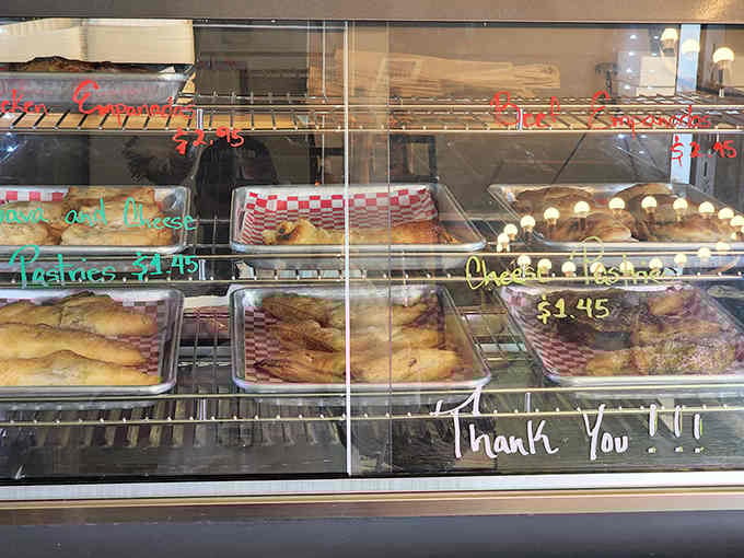 The display case showcasing fresh pastries that make you reconsider your entire breakfast strategy every single morning.