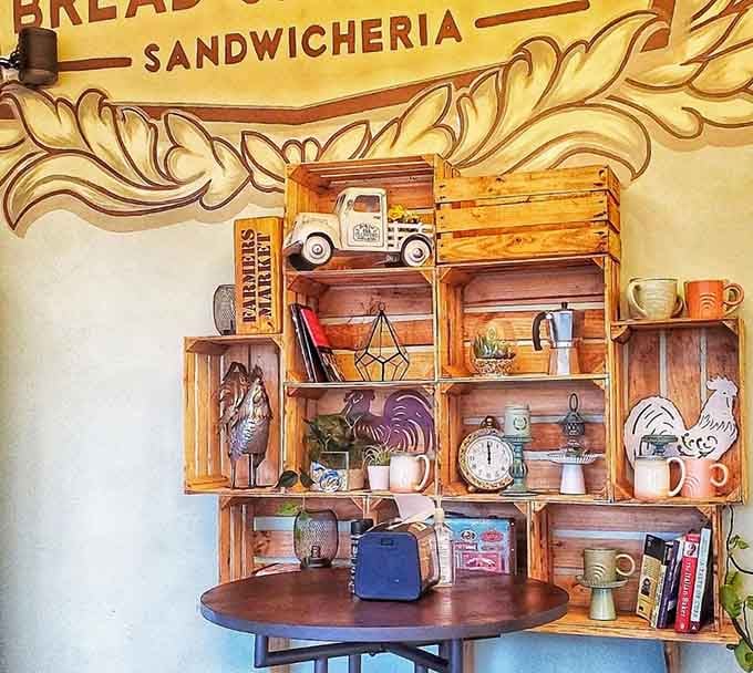 Wooden crates arranged with vintage truck and rooster decor prove that quirky charm beats corporate sterility every single time.