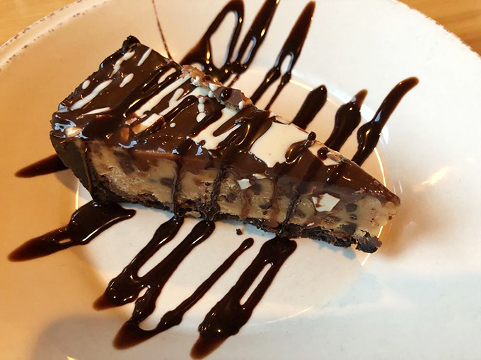 Chocolate peanut butter pie drizzled with enough sauce to make Reese's cups feel genuinely inadequate.