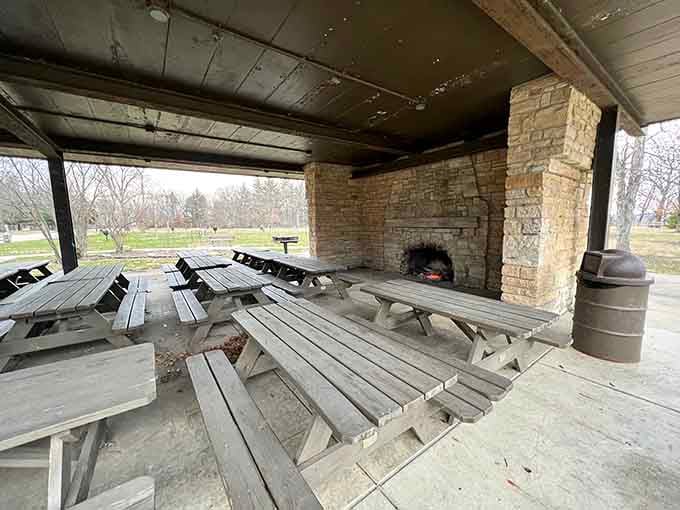 Covered picnic shelter with stone fireplace ready for family gatherings that'll create memories worth repeating annually.