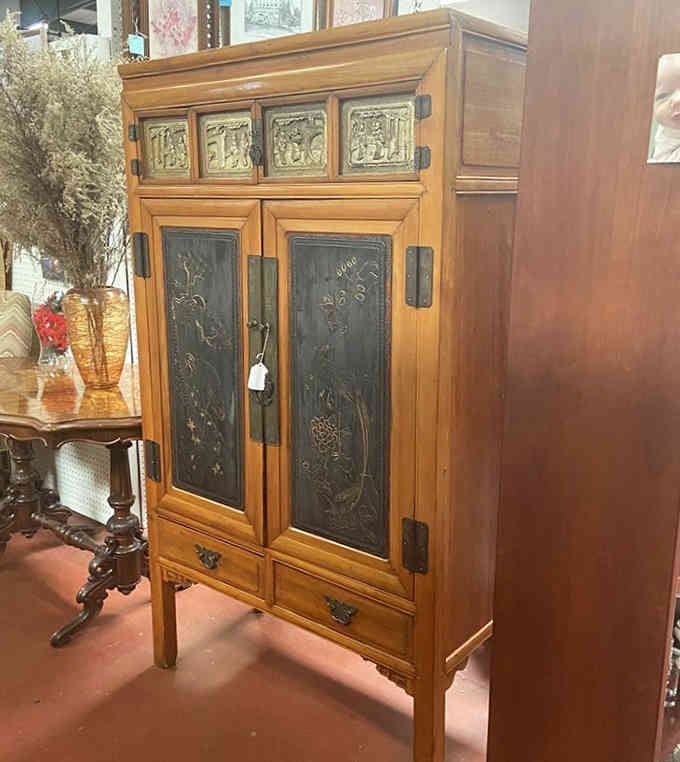 This Asian-inspired hutch has more character in its carved panels than entire furniture showrooms filled with particle board.