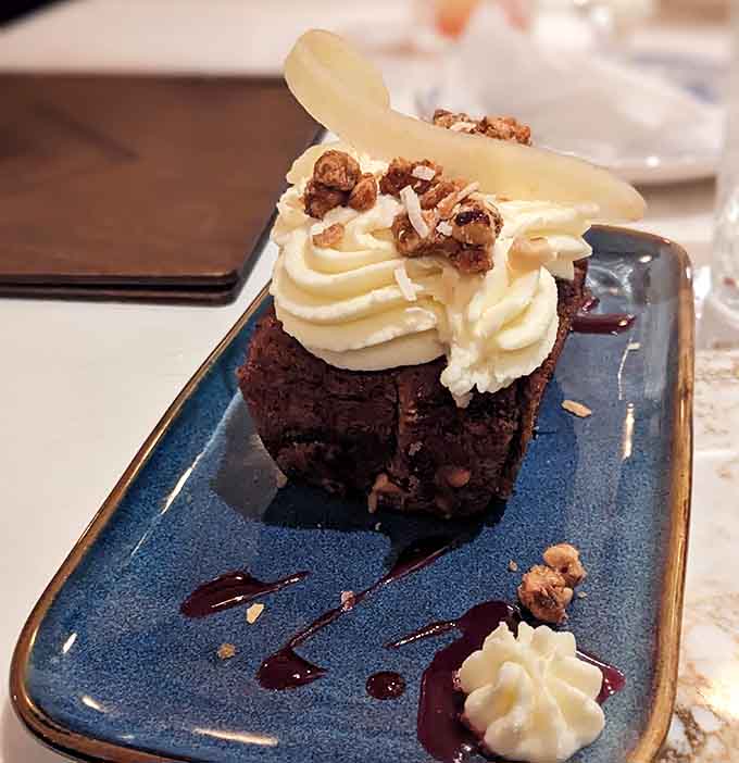 Dessert arrives looking like it graduated summa cum laude from pastry school, complete with honors and whipped cream diplomas.