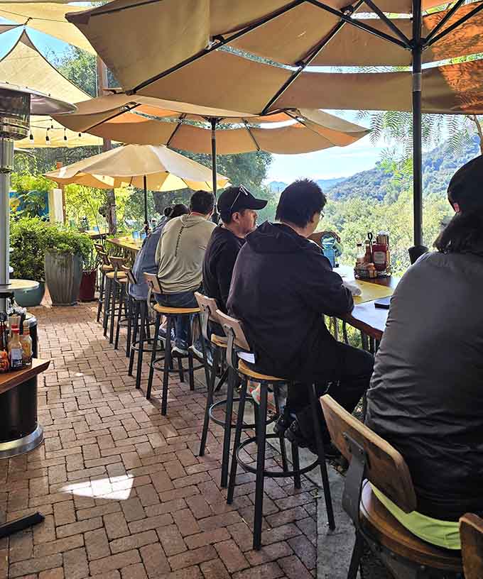 Outdoor bar seating where locals gather to enjoy their meals with mountain views, because Topanga does casual dining right.