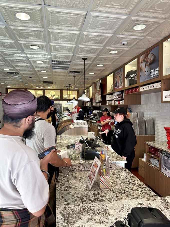 The counter where dreams are boxed up and handed over, staffed by patient souls who've seen every level of dessert-induced indecision.