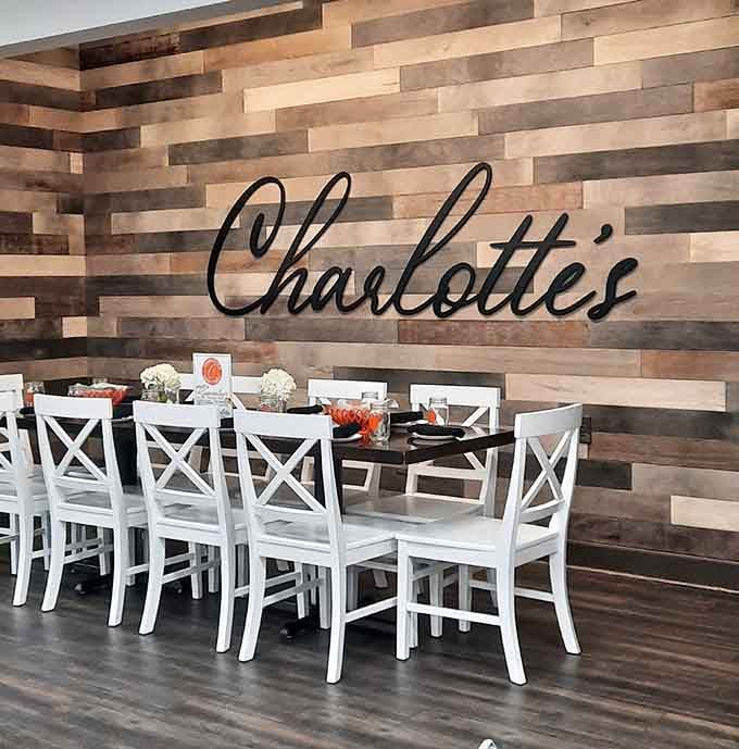 The signature wall and perfectly arranged tables invite you to sit, stay, and enjoy a proper meal.