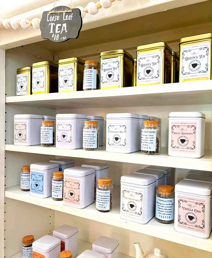 Rows of loose-leaf teas waiting like soldiers of flavor, each tin holding the promise of your next favorite blend.