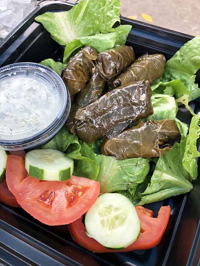 Dolmathes nestled on fresh greens&mdash;these stuffed grape leaves are proof that good things really do come in small packages.