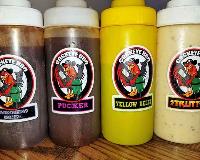 House-made sauces in every flavor profile, from sweet Yellow Belly to mysterious Pucker, each bottle promising adventure.