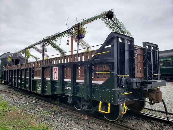 The open-air passenger car decorated with greenery offers the perfect blend of vintage travel and fresh air therapy.