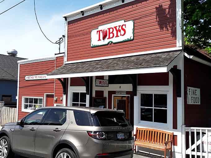 Red siding and white trim announce this waterfront tavern like a beacon for hungry souls seeking fresh seafood.
