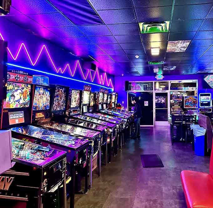 Pinball machines line up like soldiers, their colorful artwork glowing under neon lights that never went out of style.