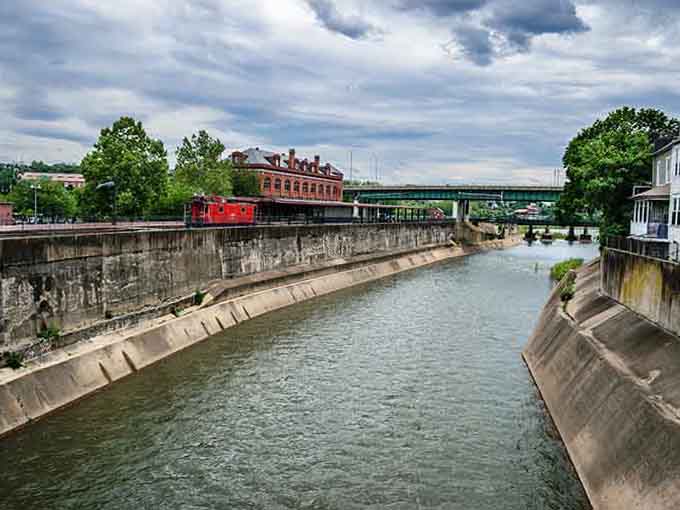 The canal system that once moved commerce now moves cyclists and hikers, which is honestly a better use of waterfront real estate.