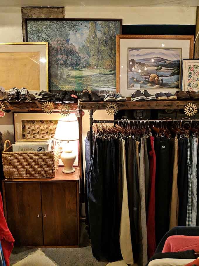 Vintage artwork casually hanging above pants like this is some SoHo gallery, not a thrift store.