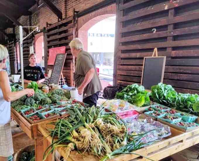 Fresh vegetables displayed on wooden crates, connecting you directly to the people who grew your dinner tonight.