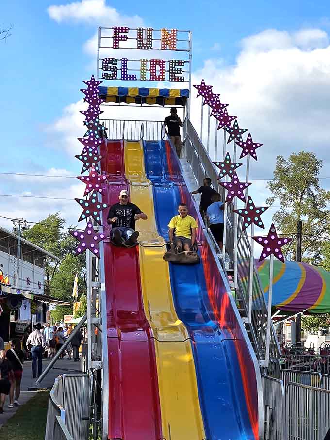 The giant slide remains undefeated as the simplest thrill at the fair, requiring only gravity and courage.