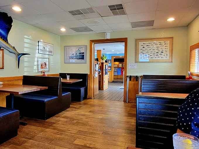 Black booths and framed coastal photography create the perfect backdrop for serious seafood appreciation and family gatherings.