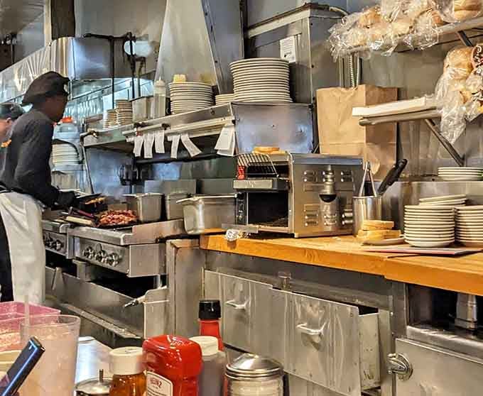 Behind the scenes, the kitchen hums with the organized chaos that produces breakfast magic every morning.