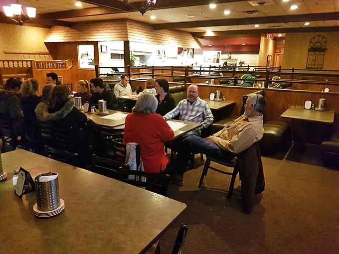 Real people enjoying real food in comfortable booths, exactly how a neighborhood pizza place should feel.