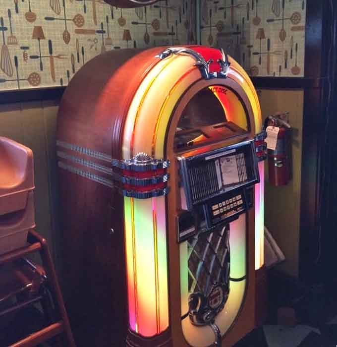 That vintage jukebox isn't just for show, it's ready to soundtrack your meal with classics that never go out of style.