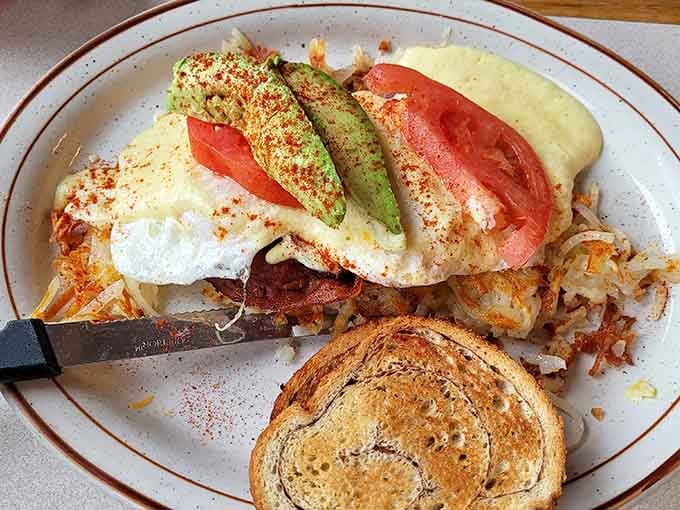 West Coast Benedict topped with avocado and tomato, proving that California and Carolina can peacefully coexist at breakfast.
