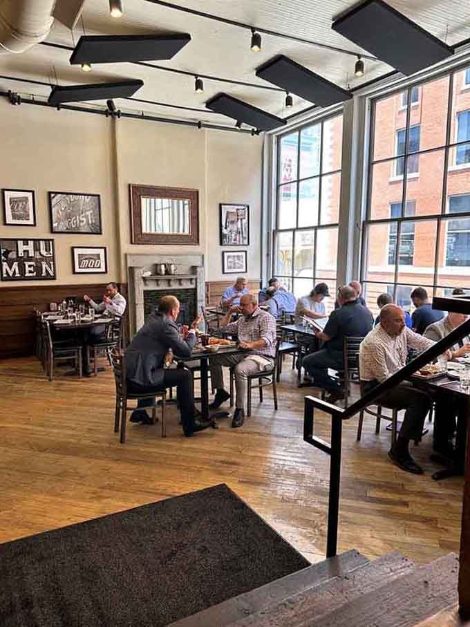 Diners enjoying their meals in a space where hardwood floors and tall windows create the perfect lunch atmosphere for downtown workers.